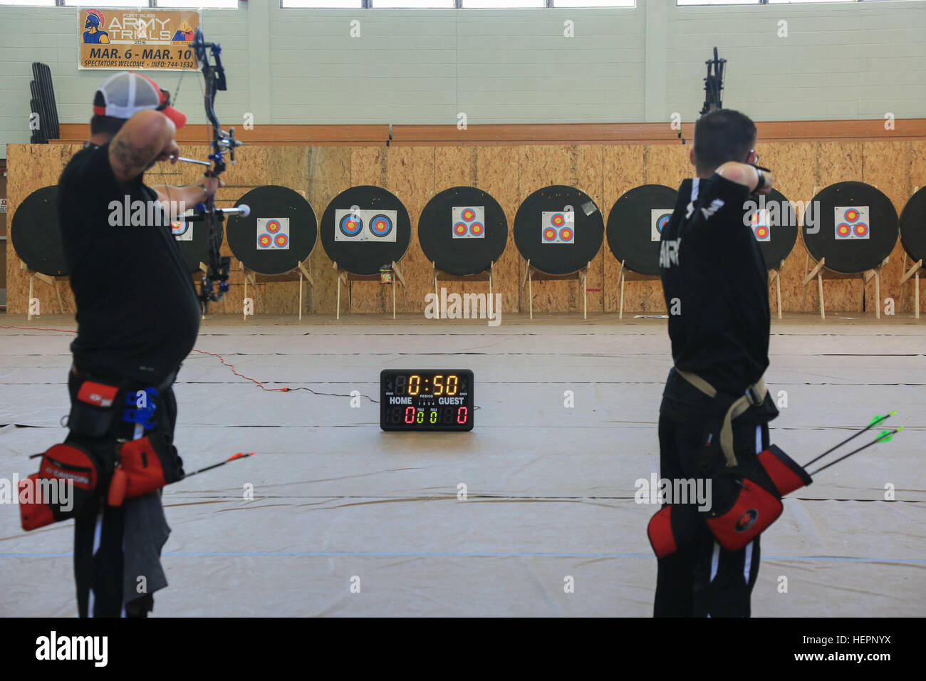 U.S Army archers prepare to release their arrows toward the targets ...