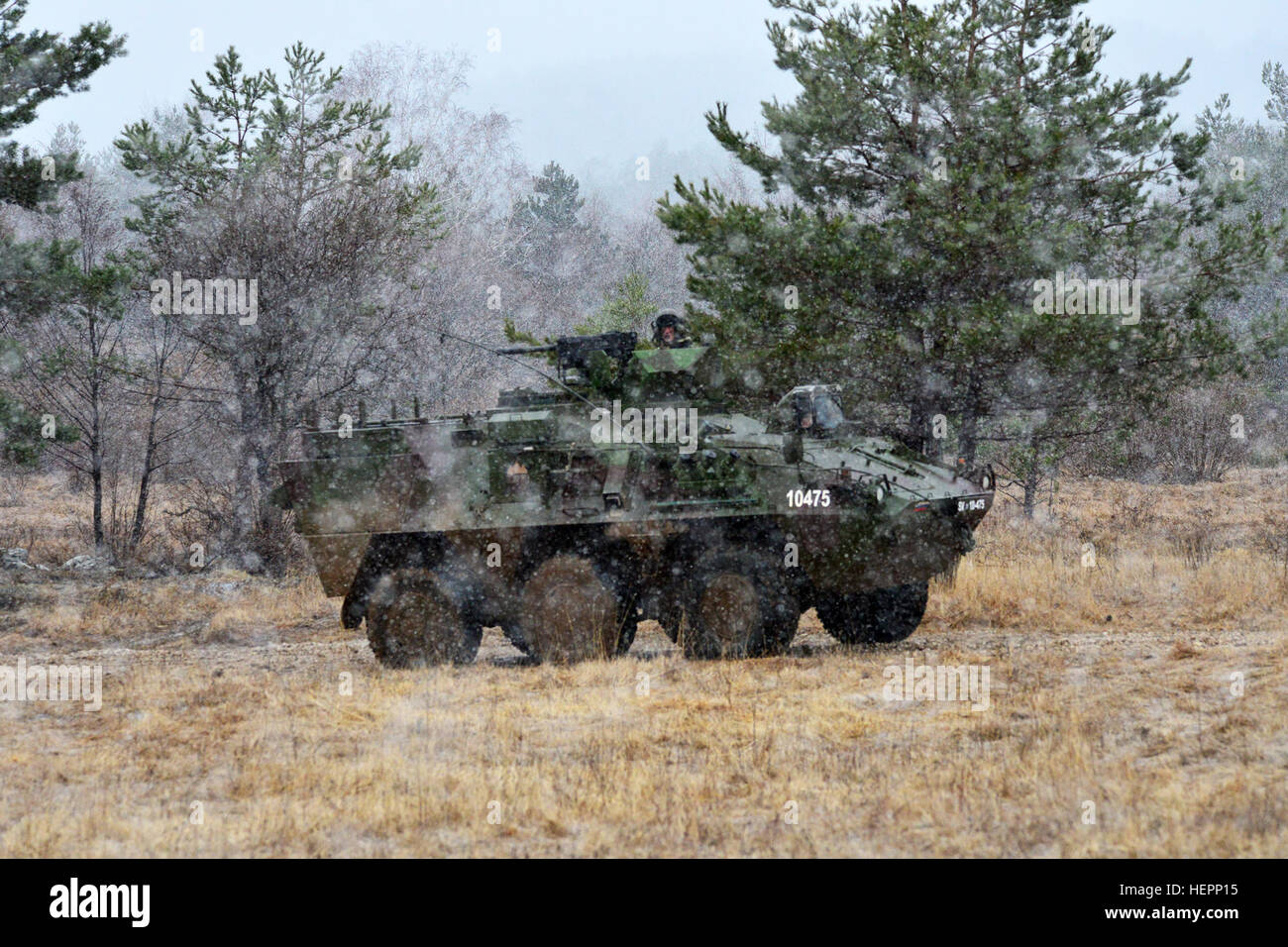 A Slovenian Valuk, a light wheeled armored vehicle, provides security ...