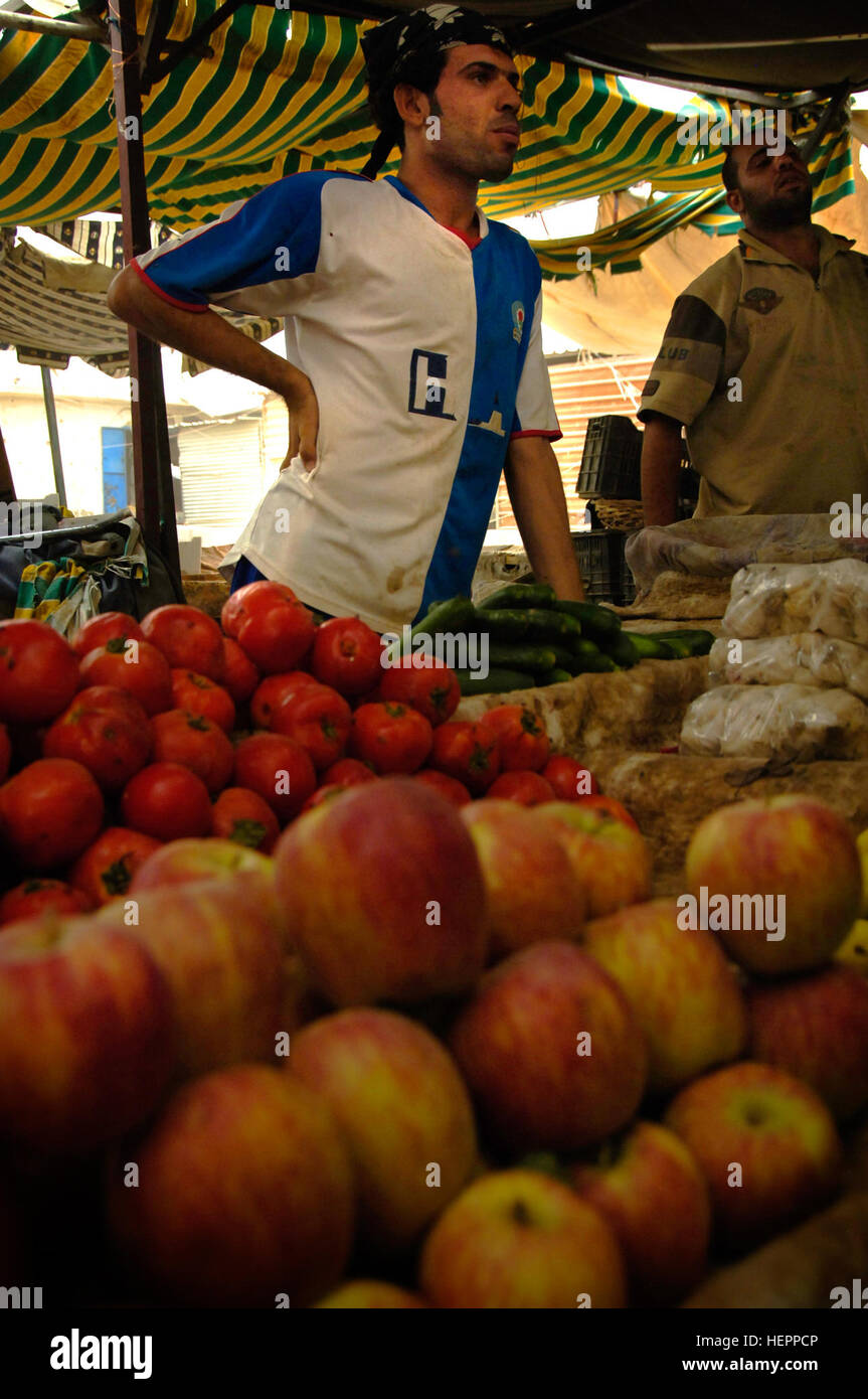 An Iraqi market vendor displays his produce at Abu Ghraib Market, Iraq ...