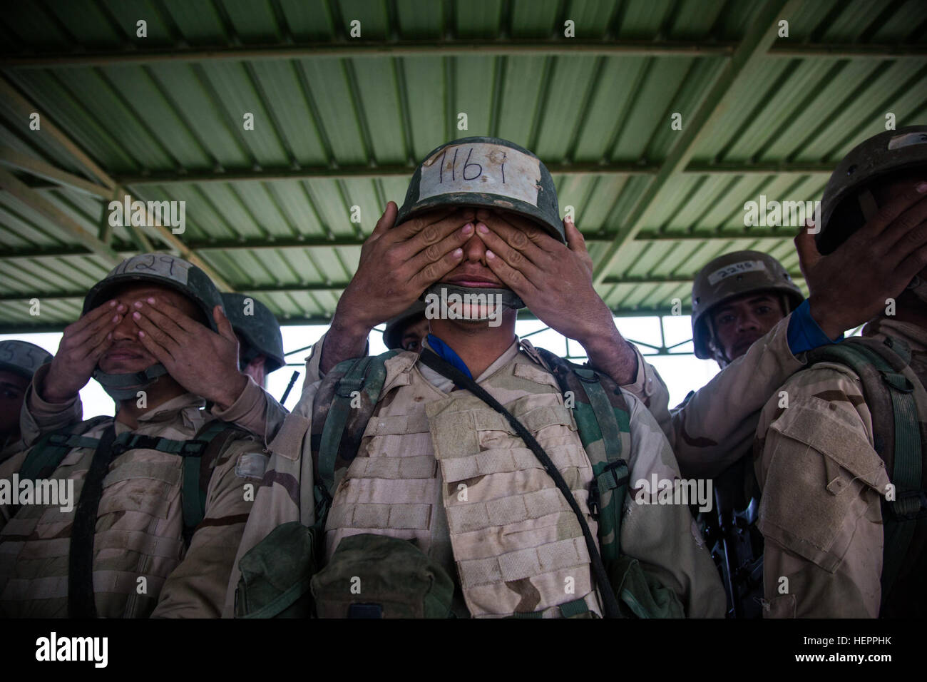 Iraqi soldiers enrolled in the Iraqi Ranger Course apply tourniquets ...