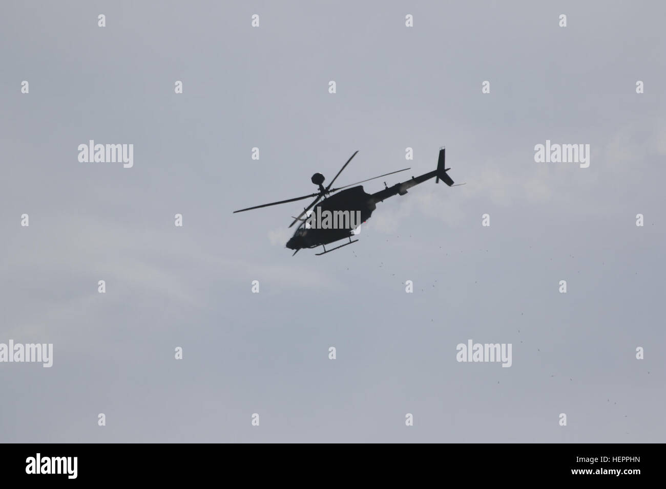 Machine gun casings fall from an OH-58 Kiowa Warrior assigned to 1st ...