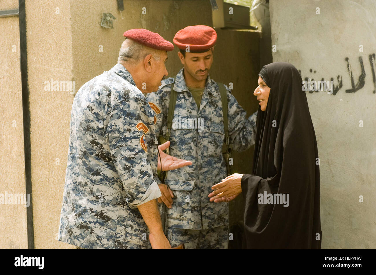 Iraqi police officers engage with a civilian outside the Izza station ...