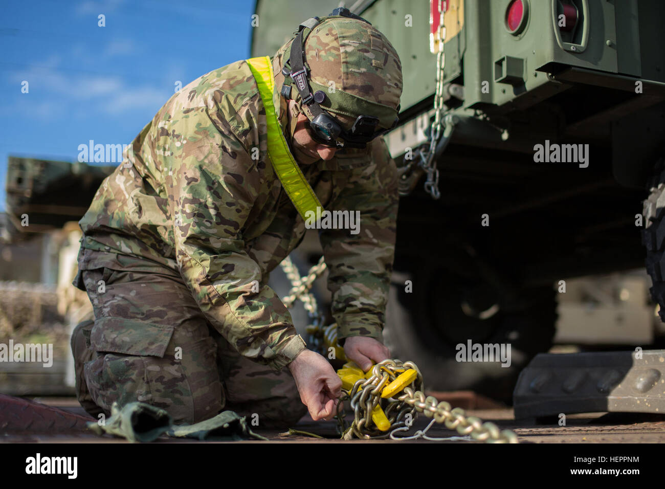 A U.S. Soldier of 173rd Airborne Brigade unchains a Humvee while ...