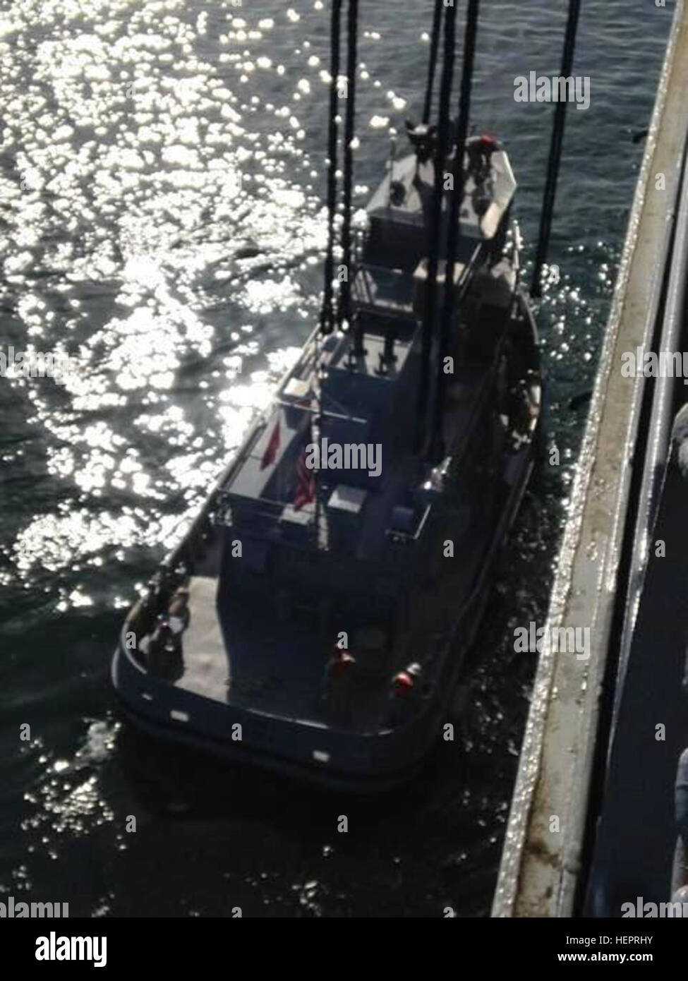 The U.S. Army small tugboat Mulberry (ST-914) is hoisted aboard the ...