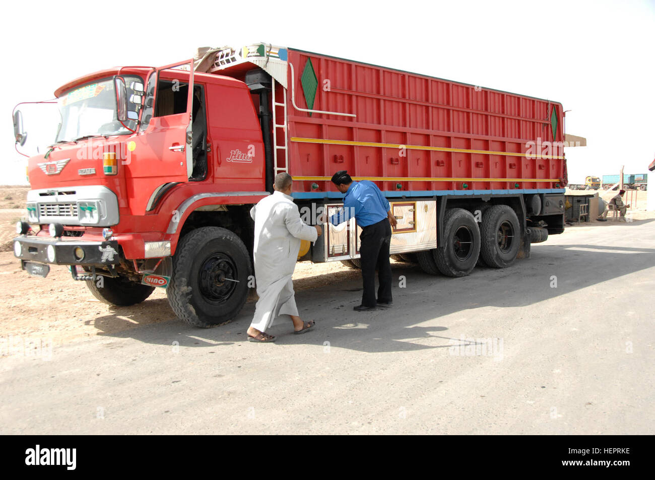 An Iraqi border guard inspects trucks at Al Sheeb, Iraq, to ensure ...