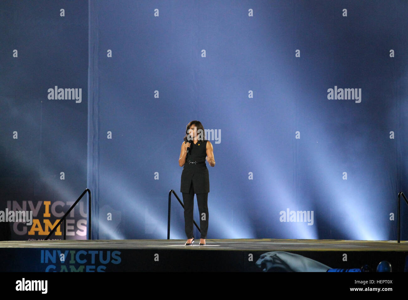 First Lady Michelle Obama greets spectators during the Opening Ceremony ...