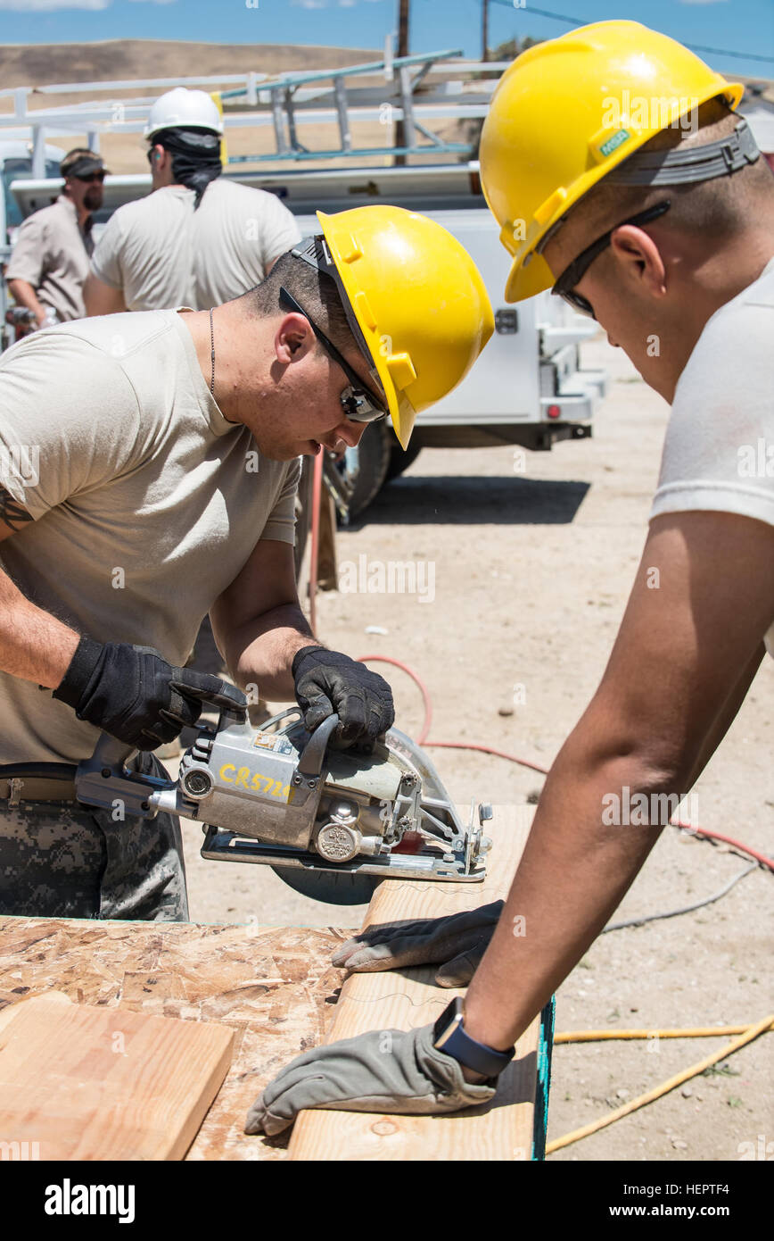 Two 315th Engineer Vertical Construction Company soldiers power saw a ...