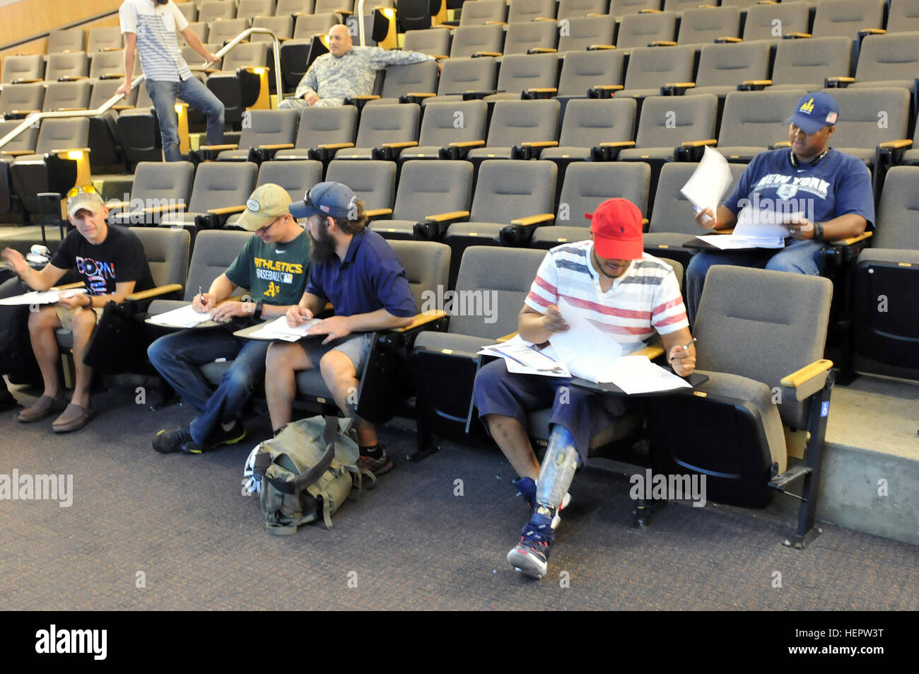 Athletes of Team Army fill out inprocessing paperwork after arriving at ...
