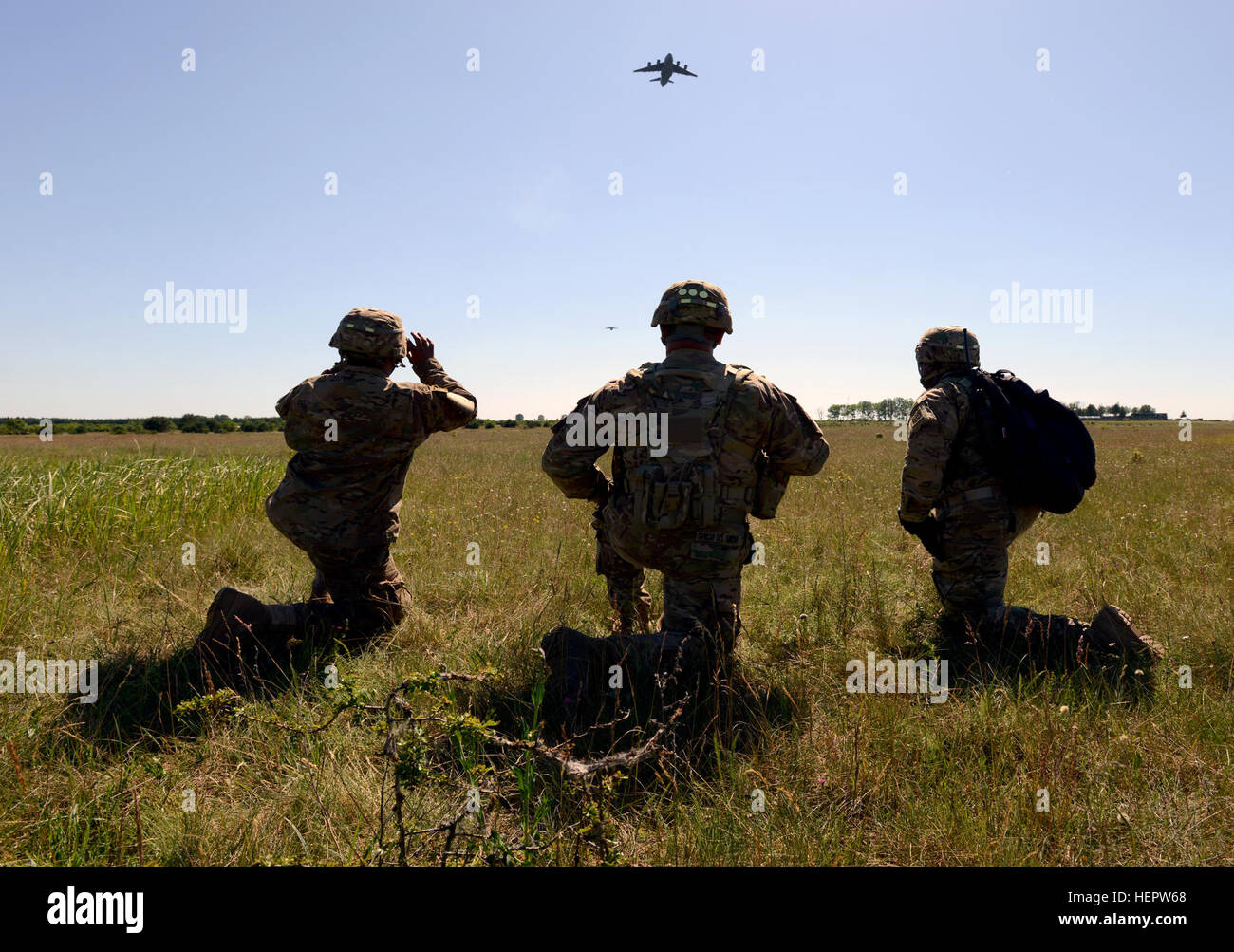 U.S. Soldiers observe as heavy equipment is dropped over the Torun Drop ...