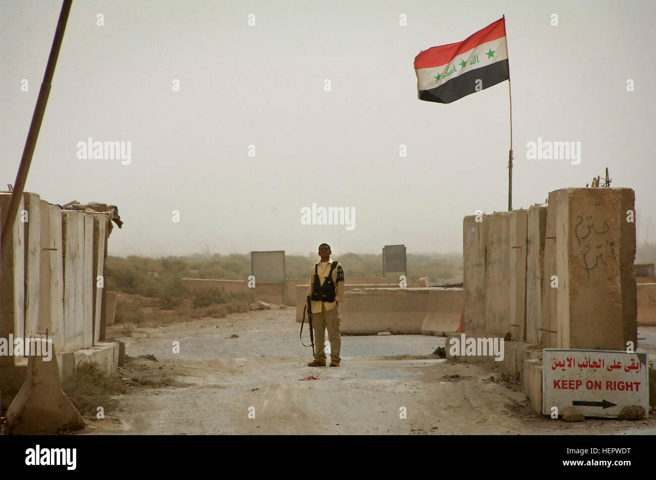 A member of the Sons of Iraq (Abna Al Iraq) stands guard a checkpoint ...