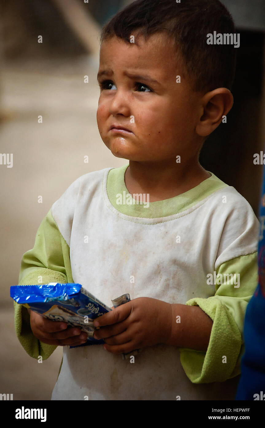 A young Iraqi boy looks up at U.S. Army Maj. Haley, 53rd Iraqi Army ...