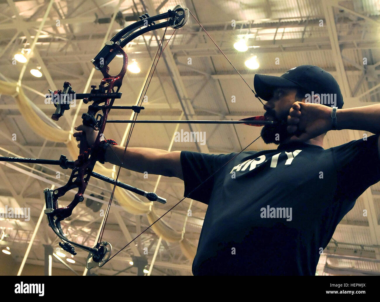U.S. Army Veteran Staff Sgt. Eric Pardo draws a bead on the target ...