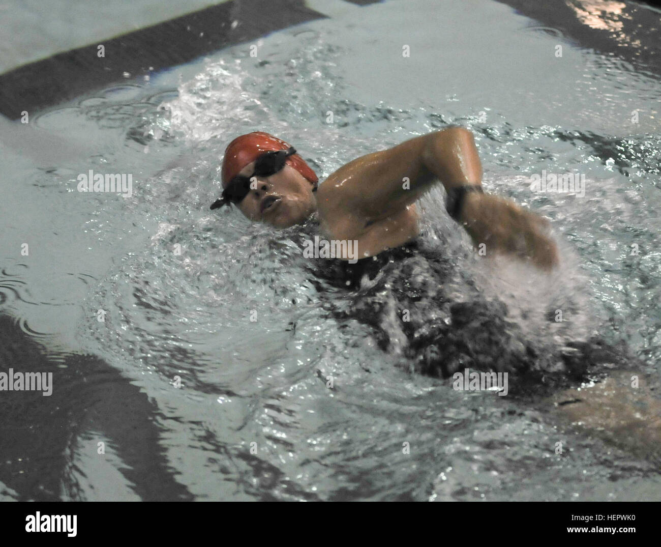 An Air Force swim team member glides through the water during a ...