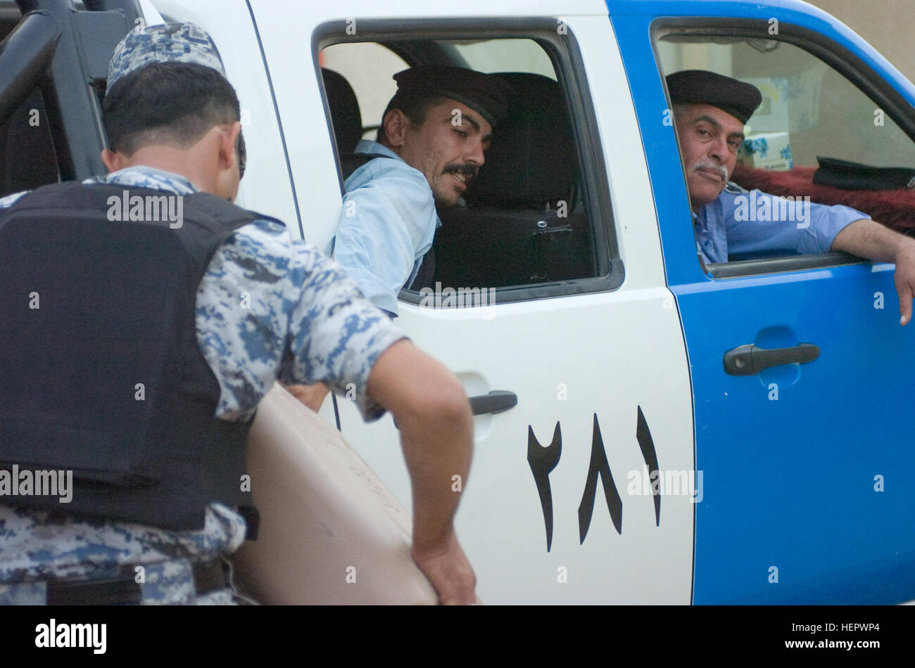 Iraqi police fuel their truck at the Izza station before embarking on a ...