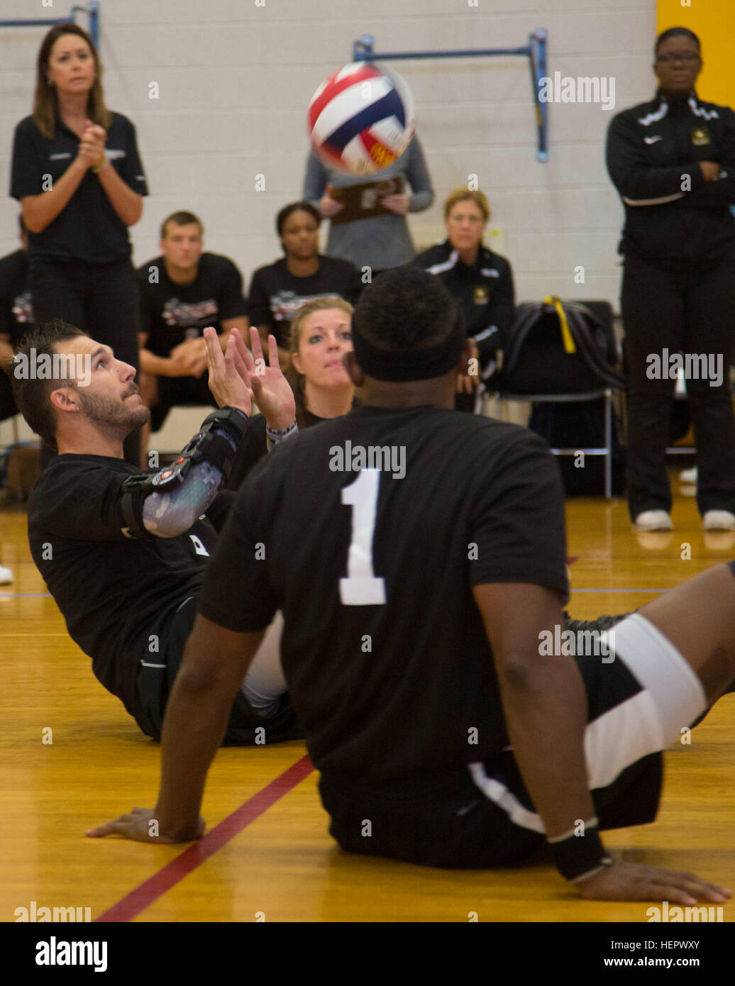 Team Army athletes participate in a sitting volleyball match against ...