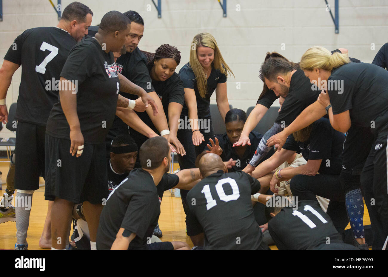 Team Army athletes gather together to discuss strategy during a sitting ...