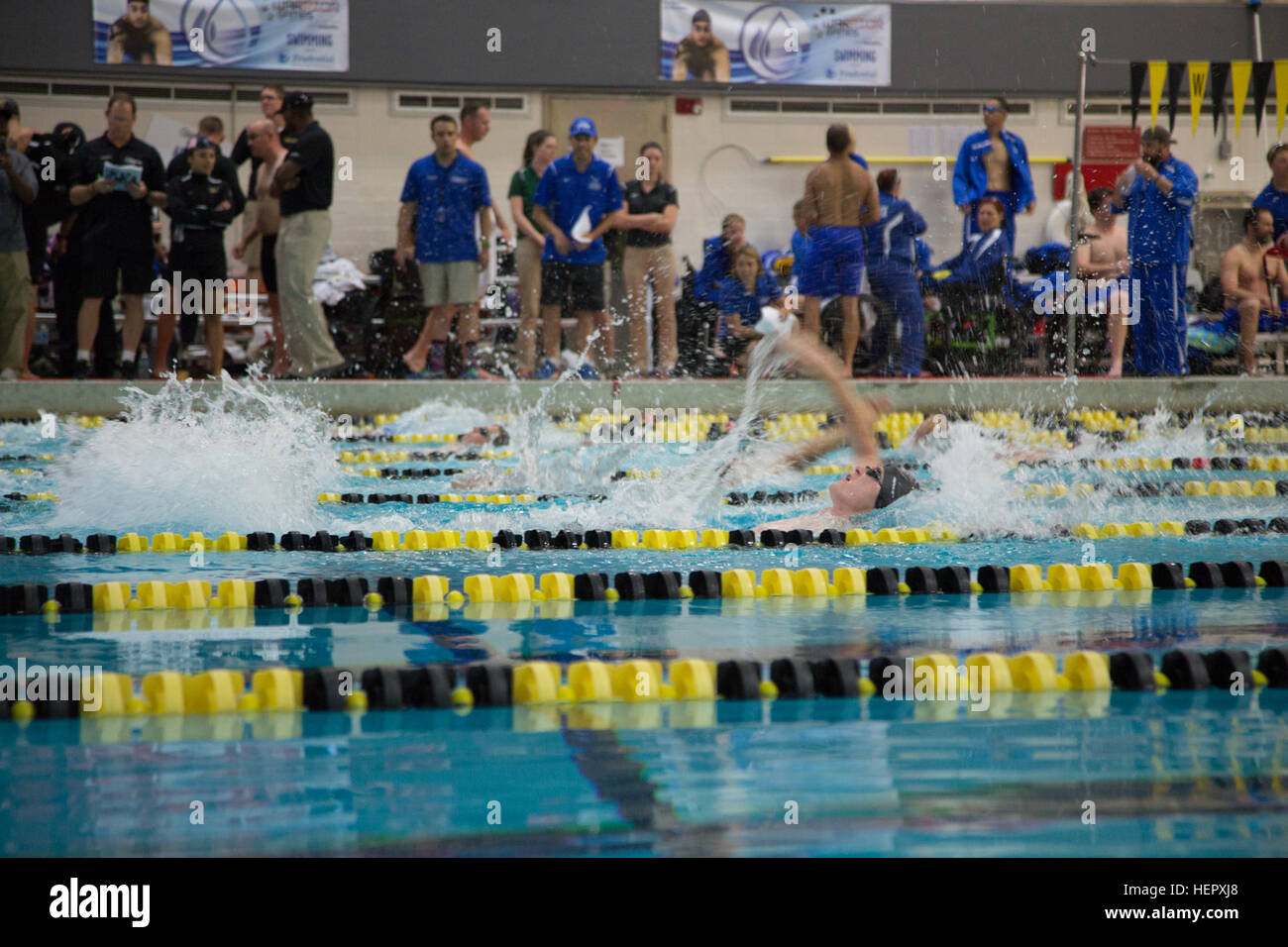 Military athletes swim in the 50-yard backstroke competition during the ...