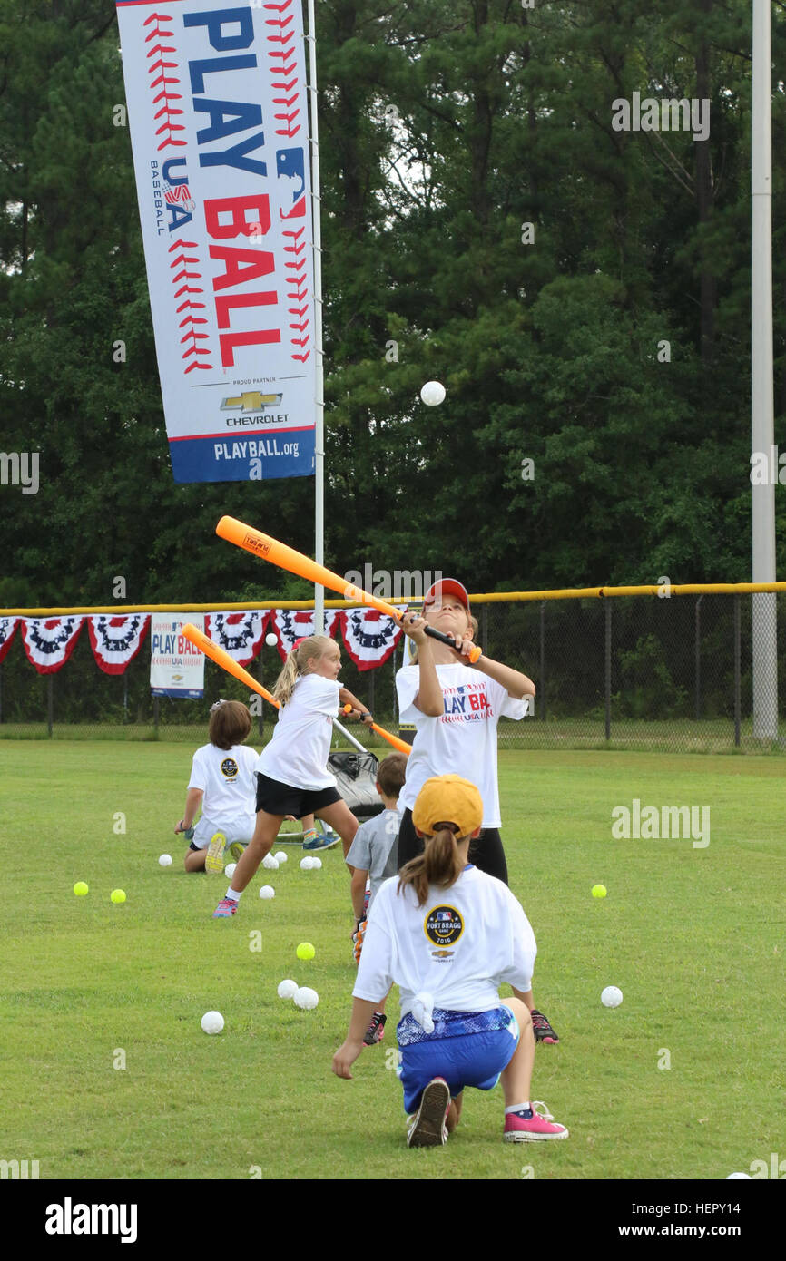 A young baseball fan swings for the fences while participating in a ...