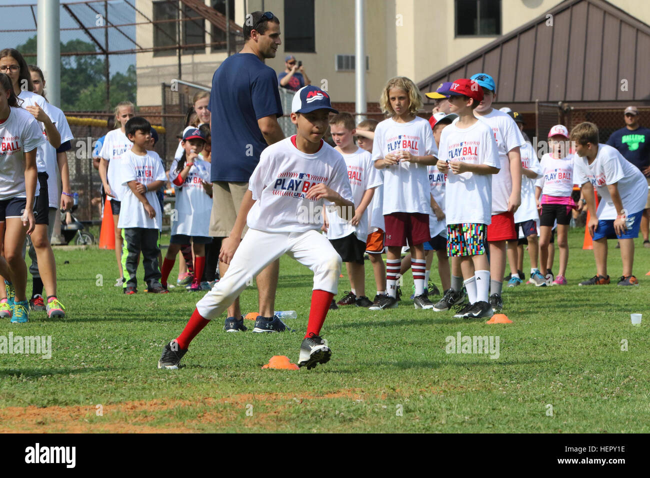 A young baseball fan moves around drill cones while participating at an ...