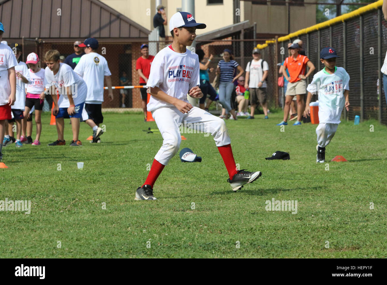 A young baseball fan moves around drill cones while participating at an ...