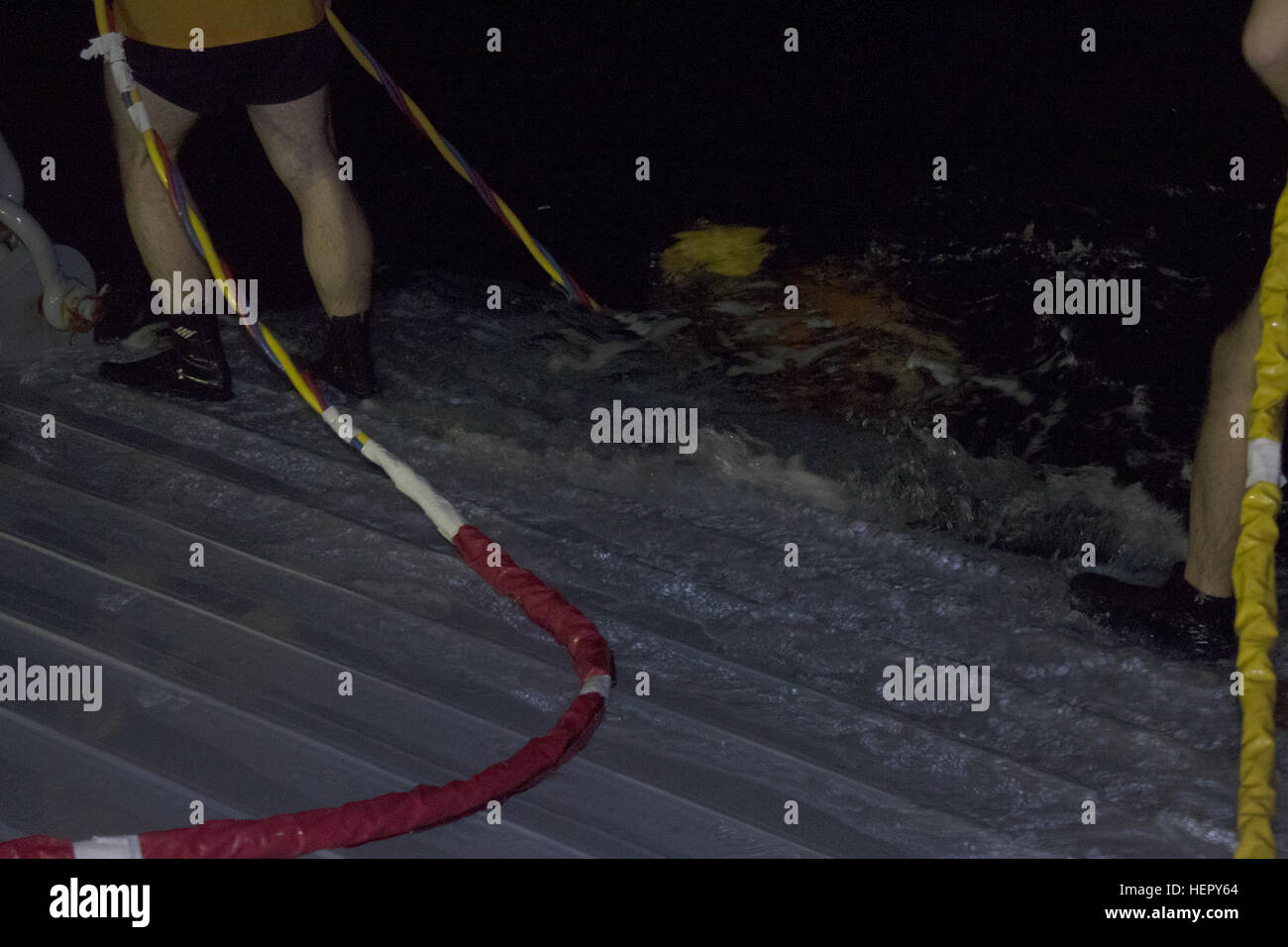 A diver from the 86th Dive Detachment secures his counterpart’s line ...