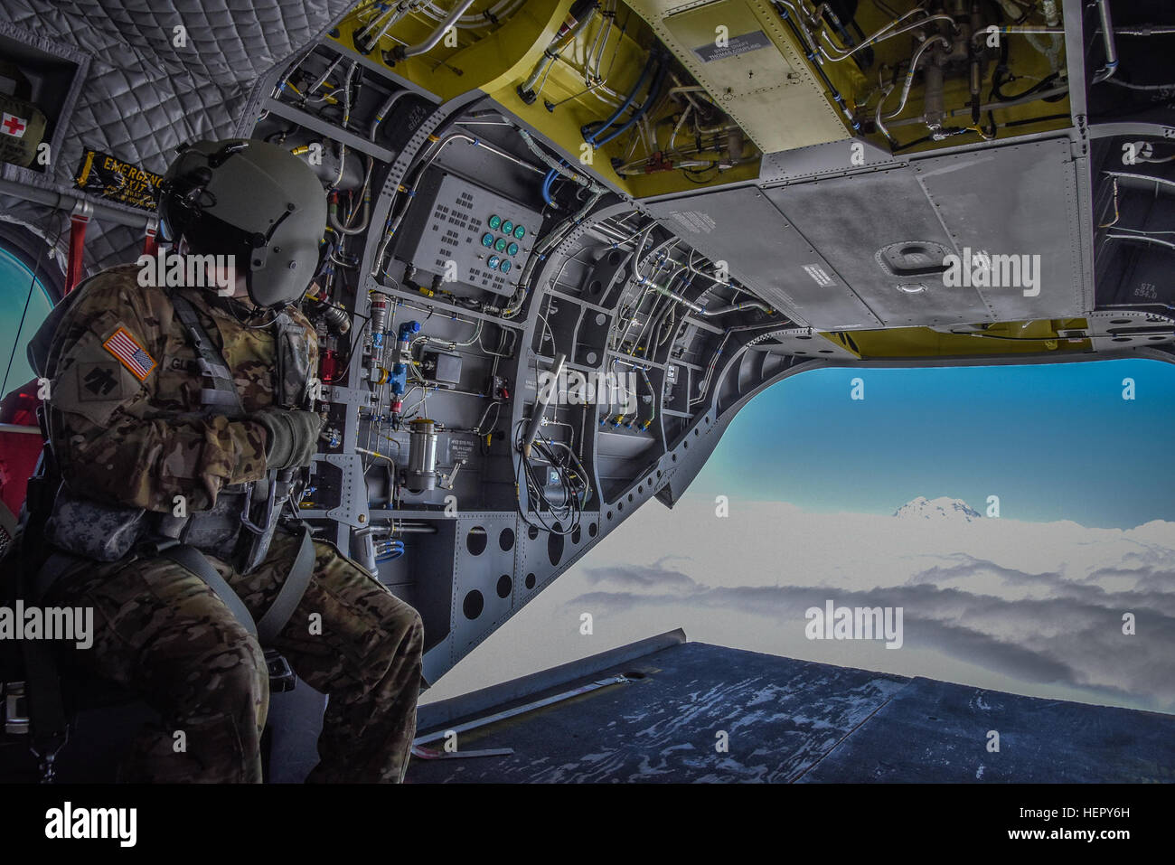 A U.S. Army Reserve aircrew communicates during a CH-47 Chinook flyover ...