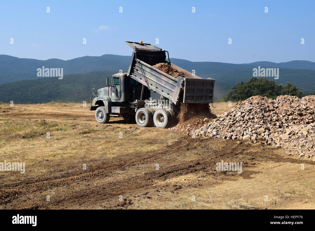 U.S. Soldiers from the 841st Engineer Battalion use a 20-ton dump truck ...