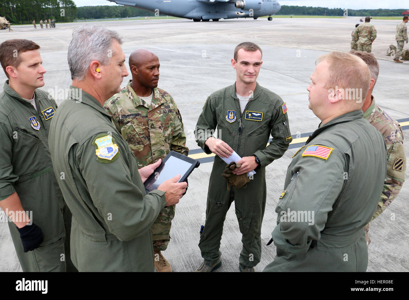 Soldiers and airmen review a load plan for an M1A1 Abrams tank at ...