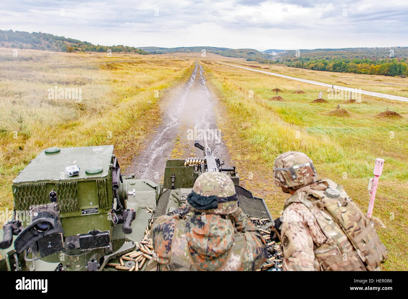 A Slovakian soldier shoots an M2 .50 Caliber machine gun mounted on an ...