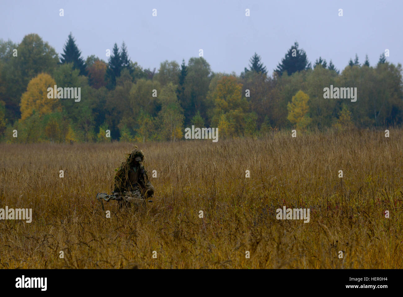 A British soldier participates in the stalking challenge at the ...