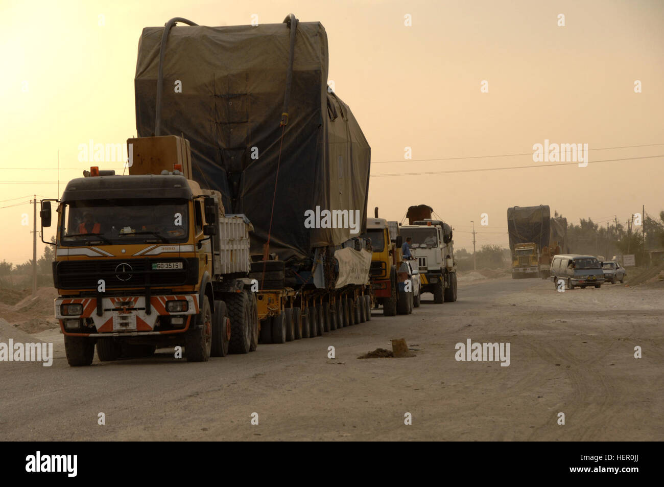 Vehicles carrying sections of a massive generator enter Baghdad, Iraq ...