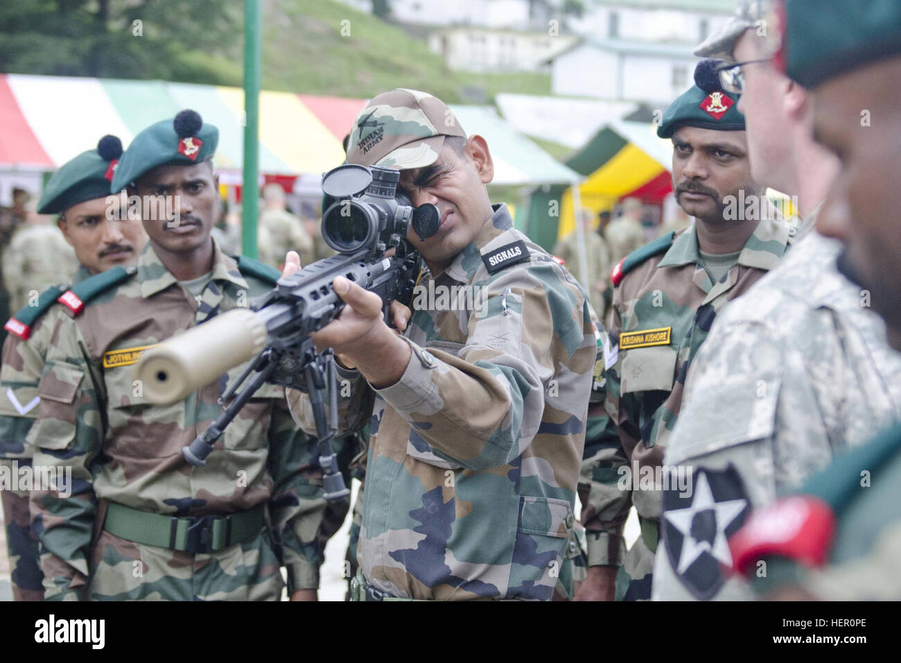 An Indian soldier looks down the sight of a sniper rifle during a ...