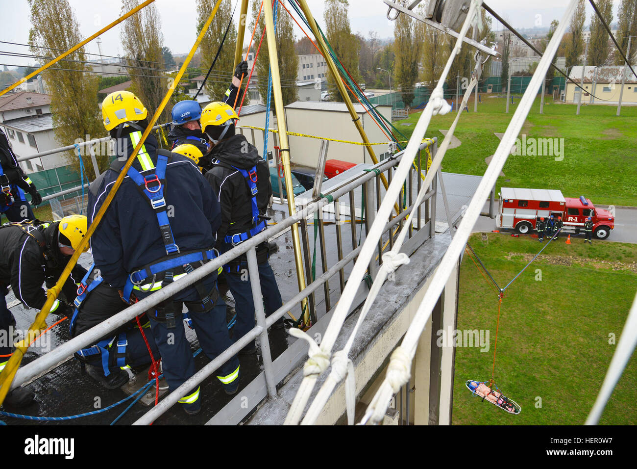 Firefighters assigned to the U.S. Army Garrison Italy, use rope work ...