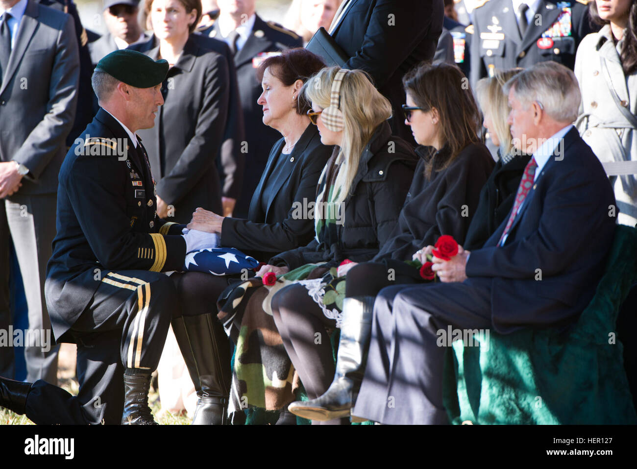 Cynthia R. Moriarty, center, receives the American flag during the ...