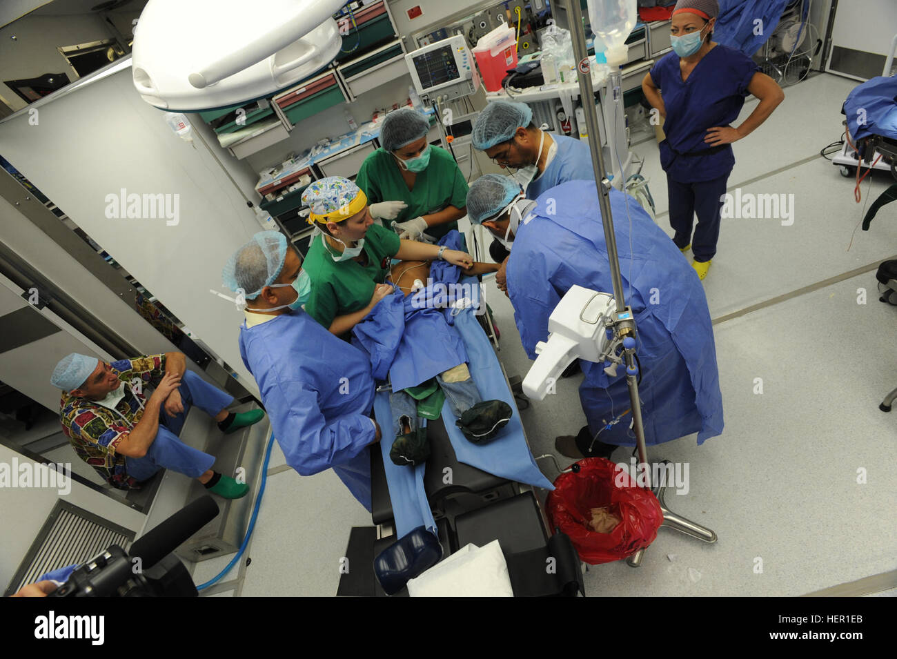 Volunteers with the Smile Train give anesthesia to a small boy before ...