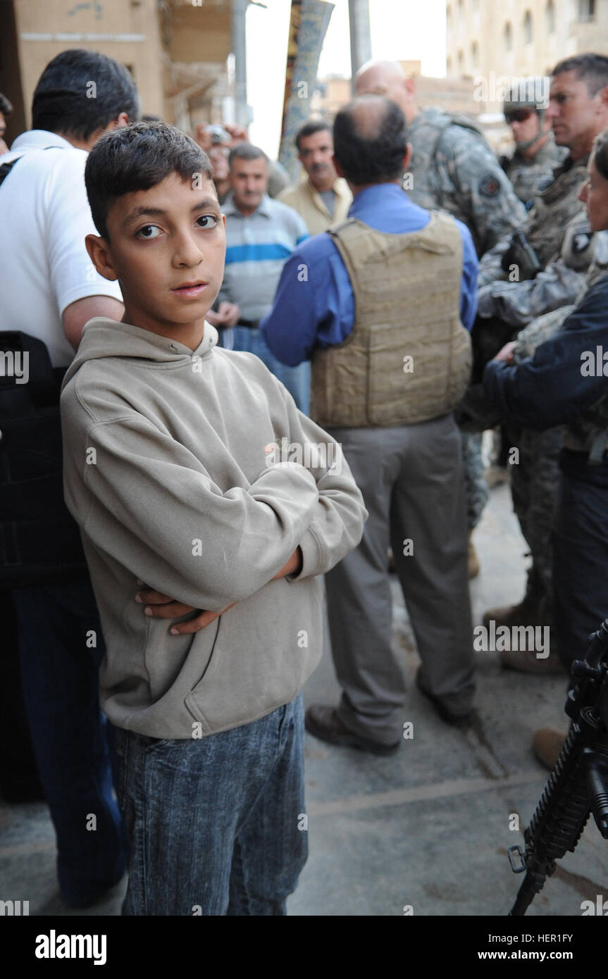 An Iraqi boy watches as Gen. Ray Odierno, commanding general, Multi ...