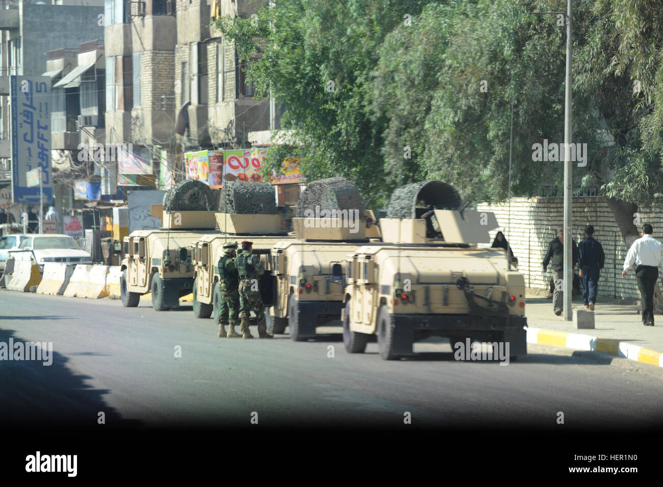 Iraqi soldiers provide security at a checkpoint around an office ...