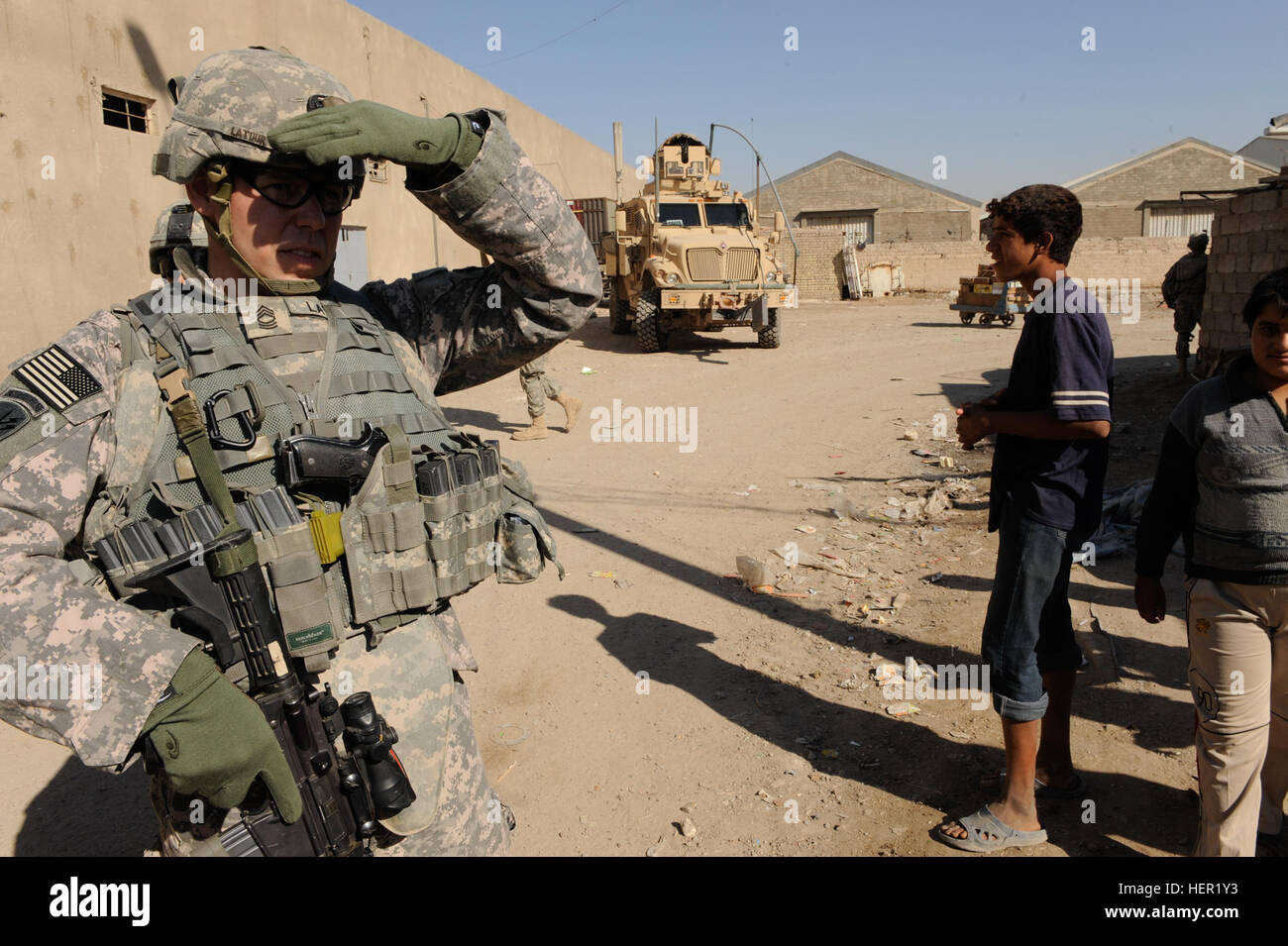 U.S. Army and Iraqi soldiers patrol the Peoples Market near Homidia ...
