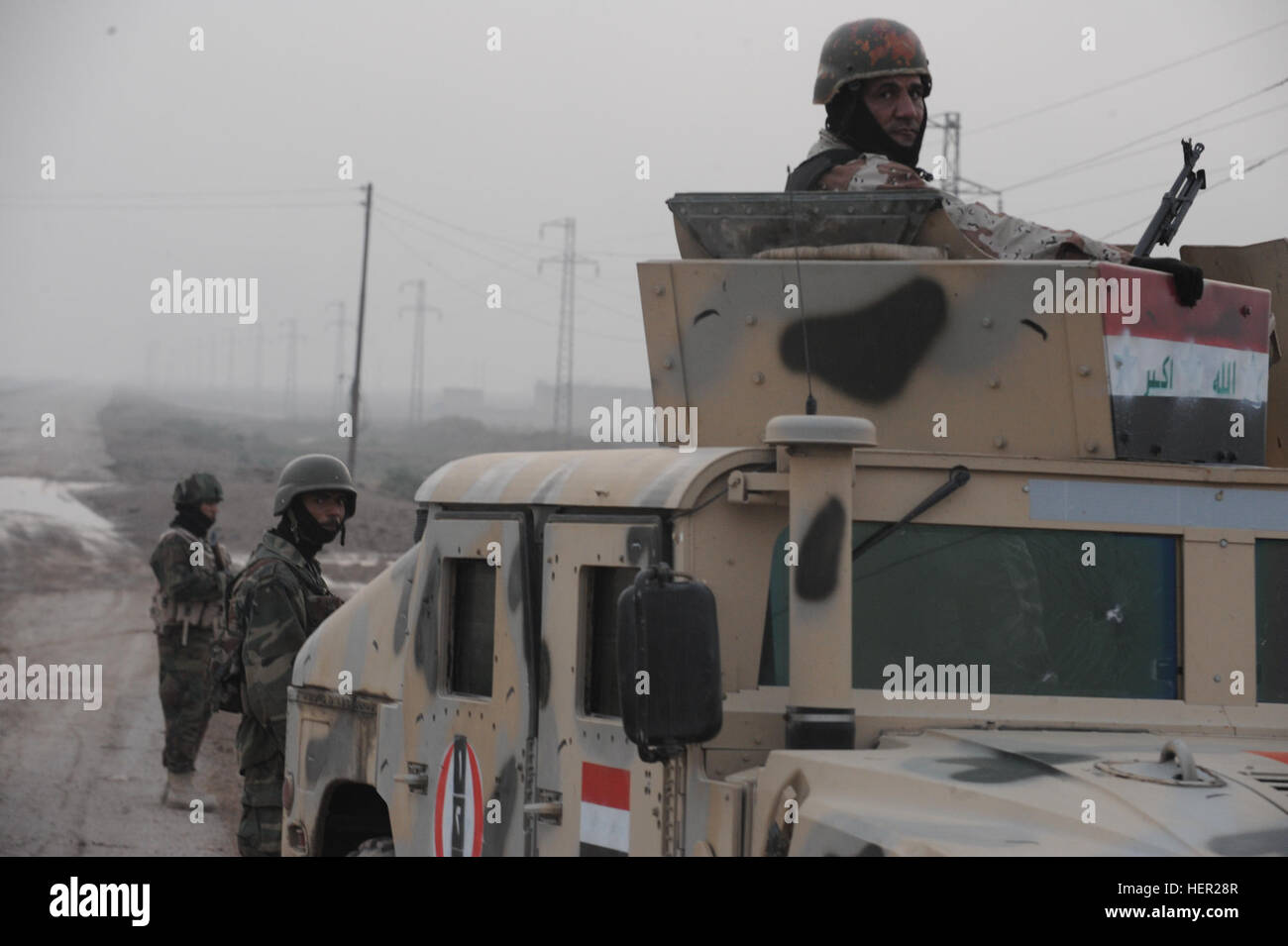 Iraqi soldiers of the Iraqi 1st Battalion, 39th Brigade, survey the ...