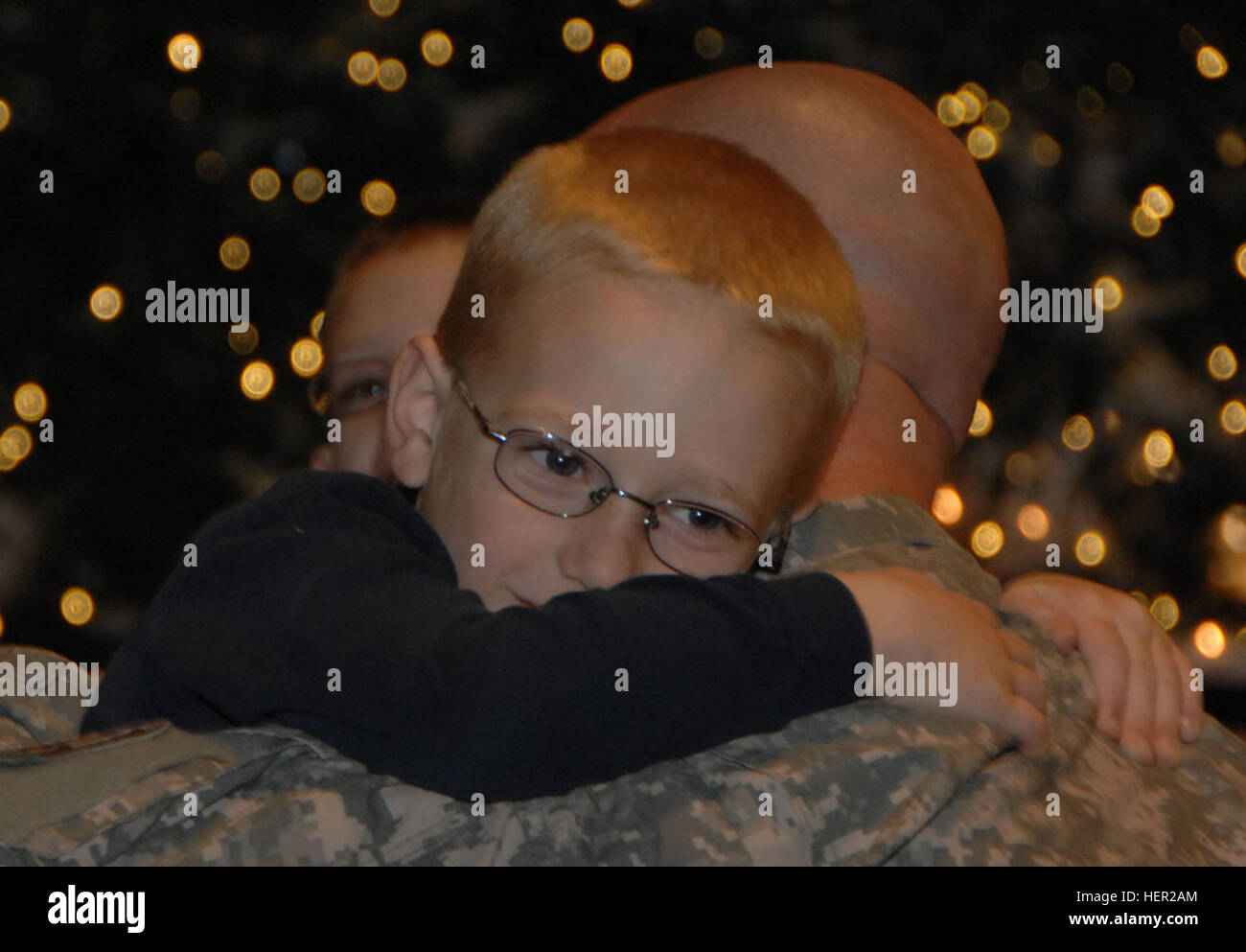 Indiana National Guard Staff Sgt. Harry Hutton, gets a hug from his son ...
