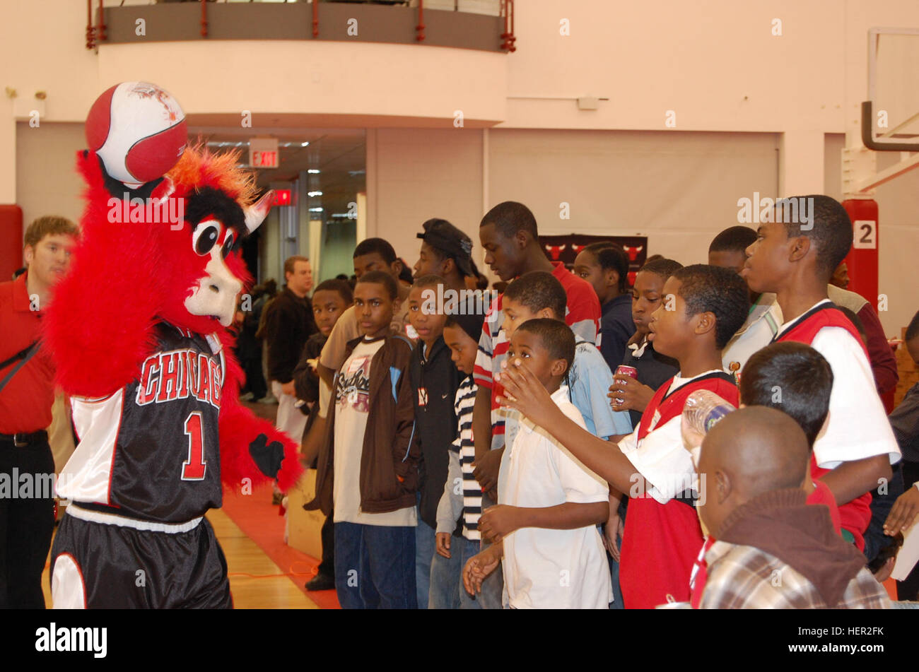 The Chicago Bulls mascot, Benny, throws the basketball to a crowd of ...