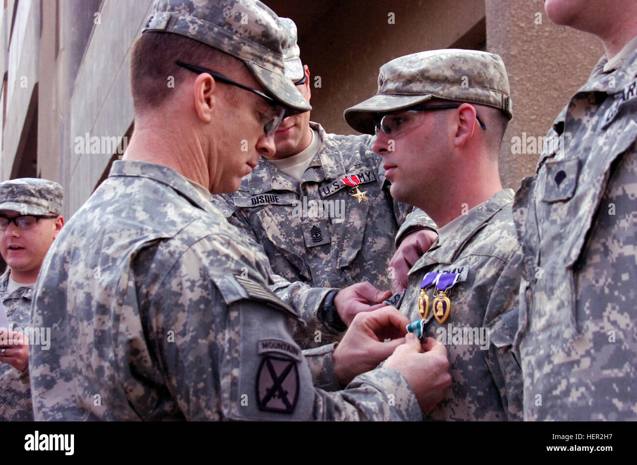Spc. Christopher Halski stands tall as Lt. Col. Gregory Baine presents ...
