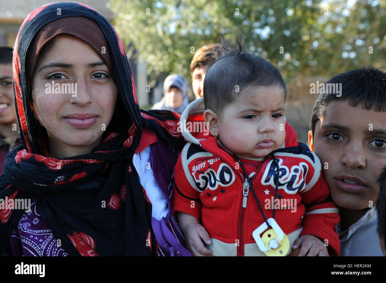 A young Iraqi mother in Al Malha, Iraq, shows her daughter to the U.S ...