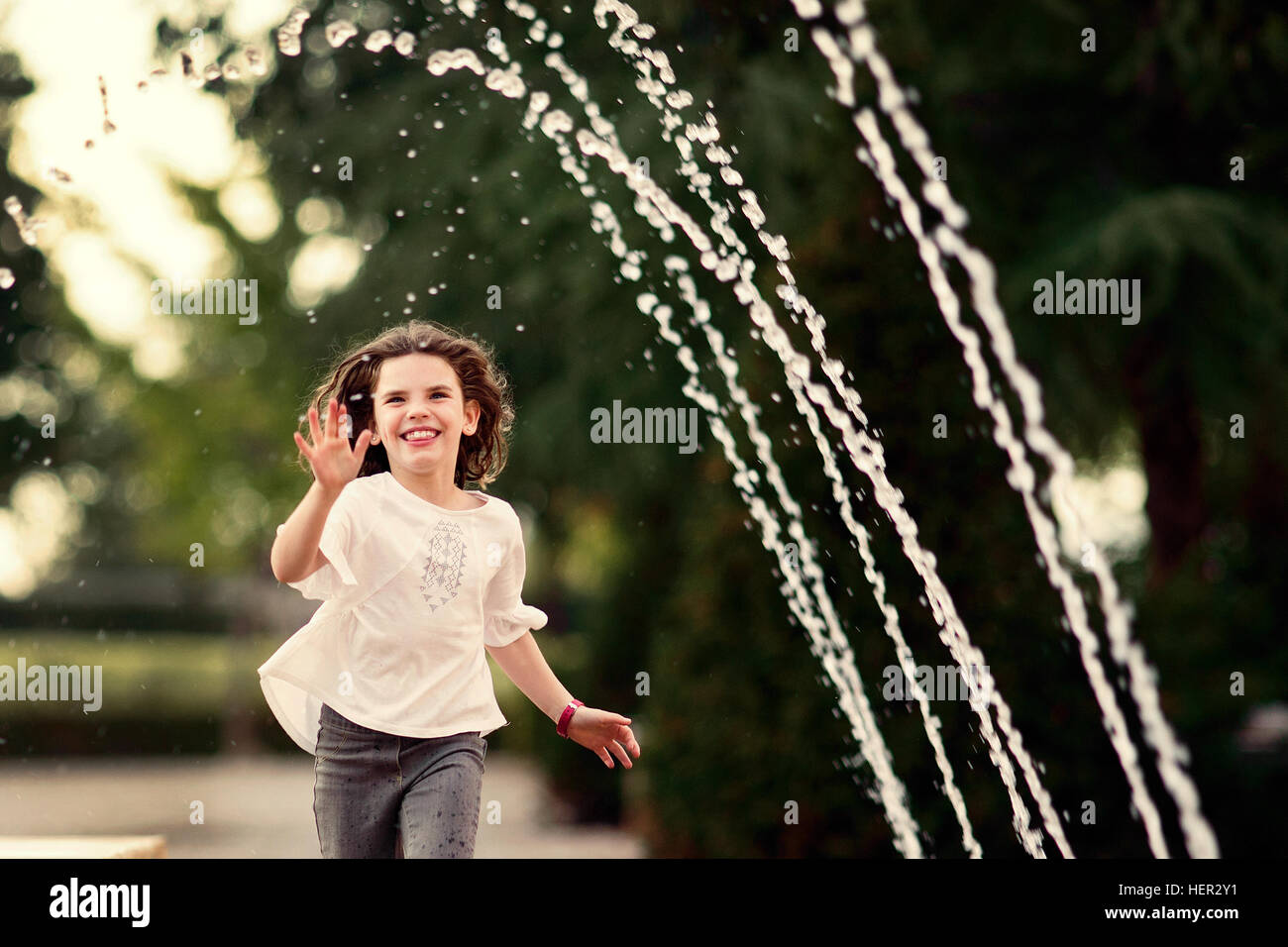 Girl running water fountain hi-res stock photography and images - Alamy