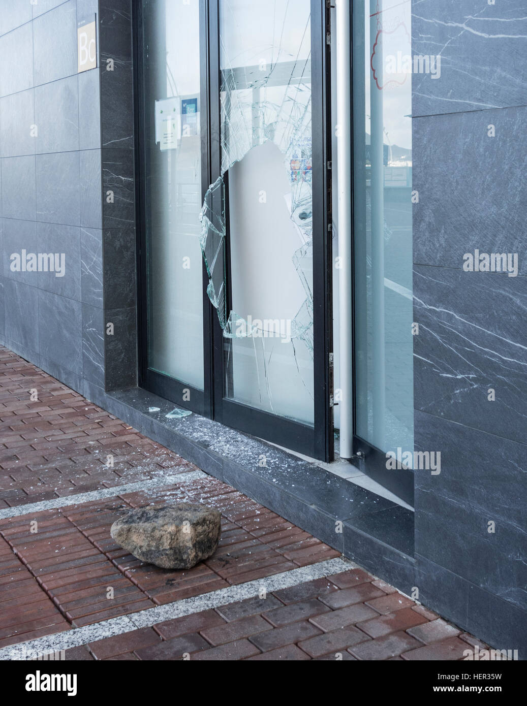 Large rock (in picture) next to smashed restaurant window/door in Spain ...