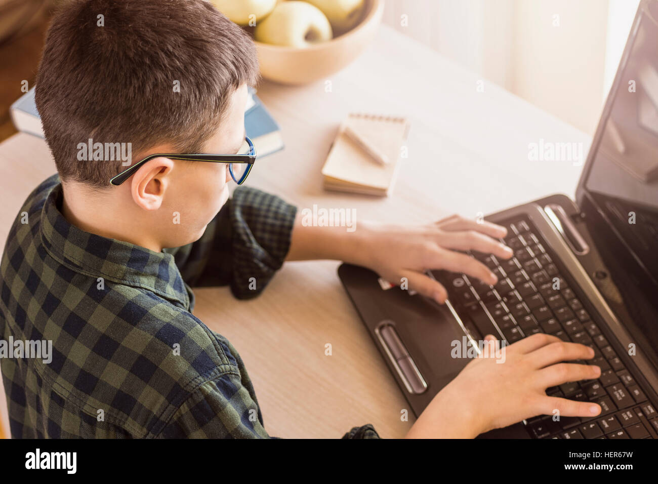 Boy With Glasses Using Laptop Computer While Sitting on Desk at Home ...