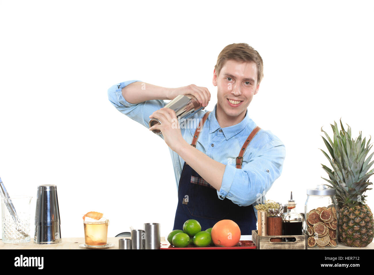 bartender with a shaker and bottle. behind the bar Stock Photo - Alamy