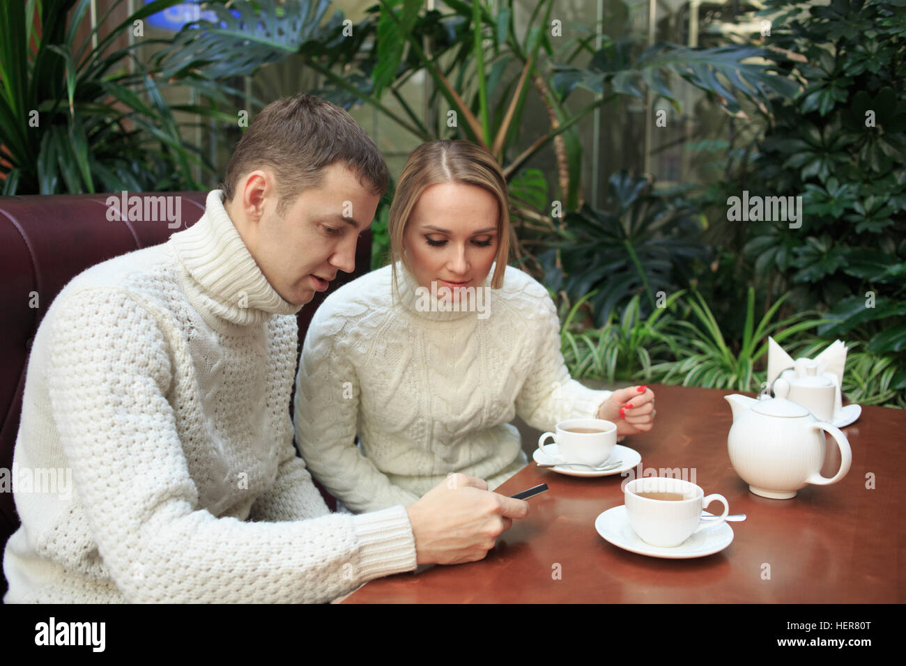 Romantic young couple drinking coffee Stock Photo - Alamy