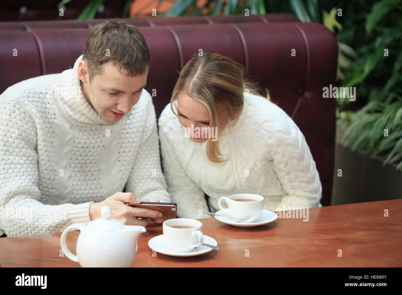 Romantic young couple drinking coffee Stock Photo - Alamy