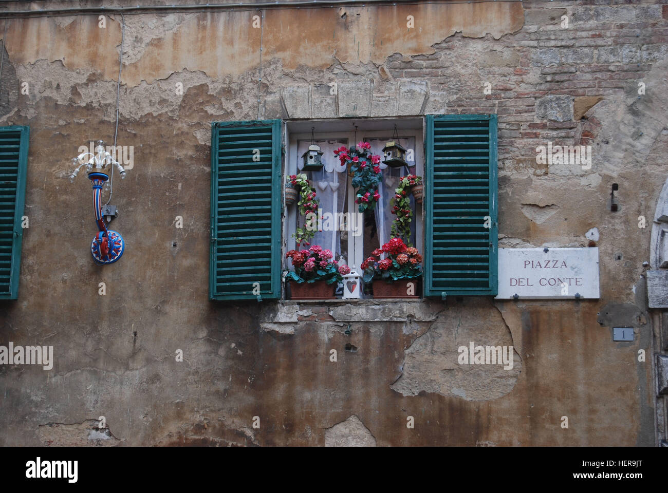 Decayed house facade with street lights and a window decorated with ...